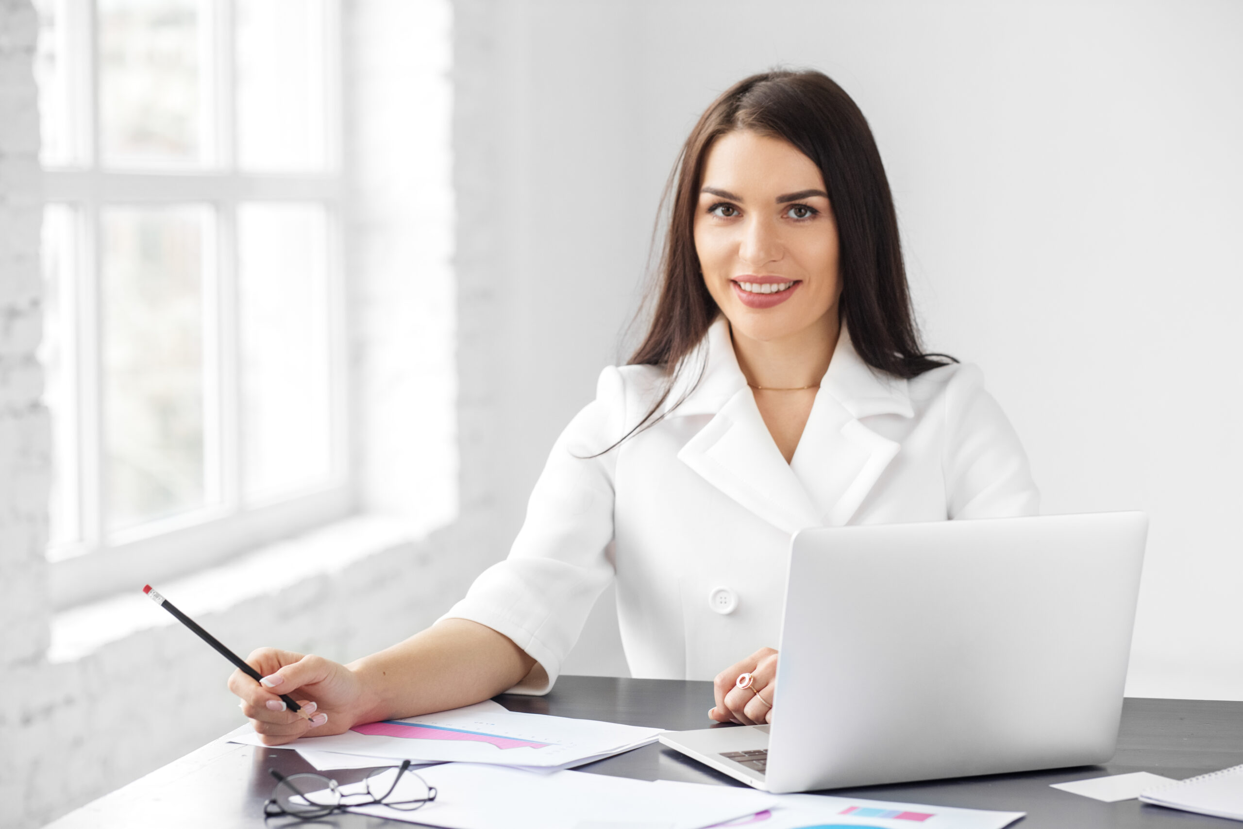 A young adult woman is working and smiling. Concept for business, work ...
